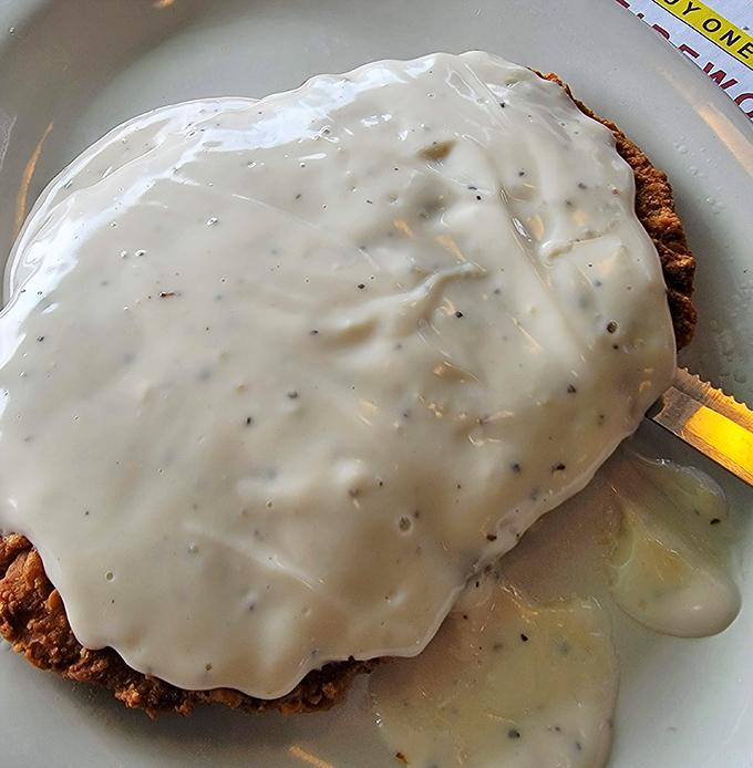 Country fried steak swimming in creamy gravy&mdash;proof that sometimes the most delicious things aren't the most photogenic. Pure comfort.