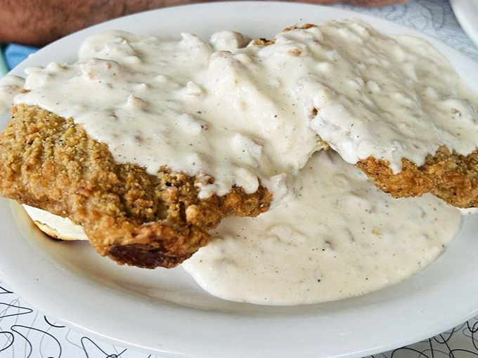Country fried steak swimming in creamy gravy&mdash;the kind of dish that makes you want to hug the chef and then take a well-deserved nap.