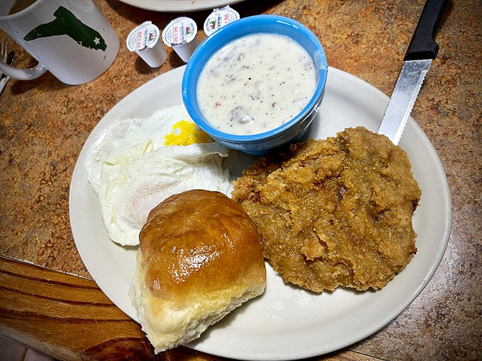 Country fried steak that achieves the impossible trifecta: crispy exterior, tender interior, and gravy that should be declared a national treasure.