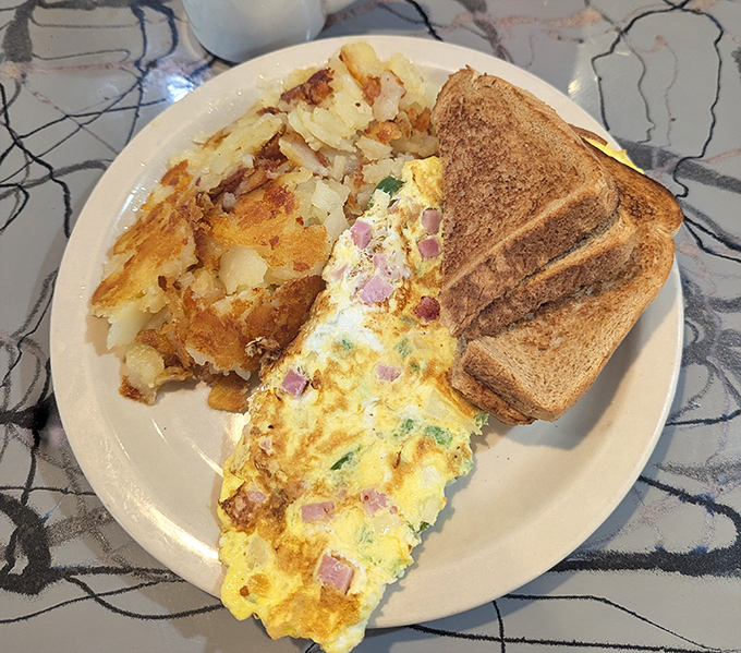 This isn't just an omelet &ndash; it's a savory morning masterpiece with home fries that crackle with each bite.