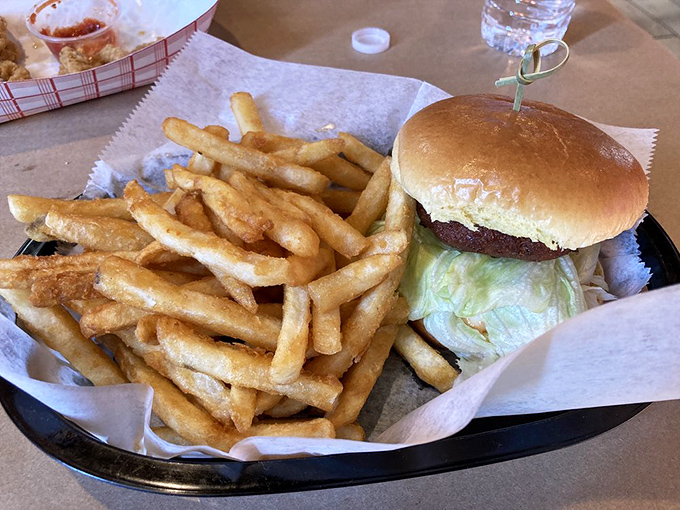 Golden crab cake perfection sits proudly beside crispy fries, creating a harmony that would make angels weep.