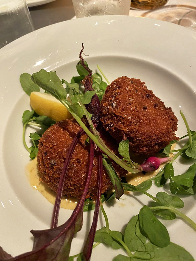 These crab cakes aren't just good, they're "text your foodie friends immediately" good, perched atop a bed of peppery greens.