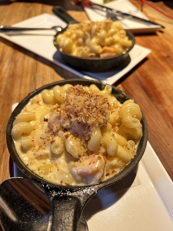 The legendary Crawfish Mac & Cheese arrives in its own skillet throne. Creamy, decadent, and worth every single calorie-laden, magnificent bite.