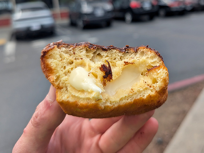 The cross-section reveals the holy grail of cream-filled donuts: the perfect dough-to-filling ratio that modern science still can't explain.