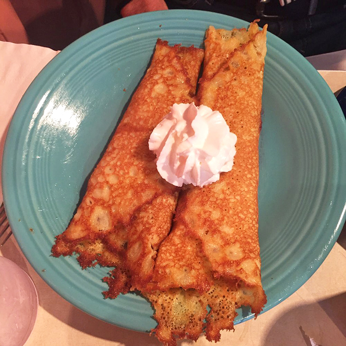 French toast that's achieved the perfect golden-brown complexion, with a dollop of whipped cream playing the supporting role it was born for.