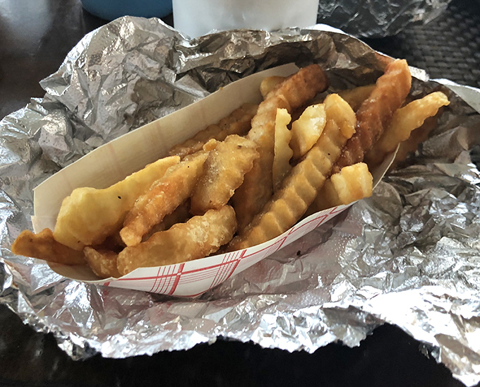 Golden crinkle-cut fries – the perfect sidekick to any sandwich superhero. Crispy, salty, and ready for their supporting role.