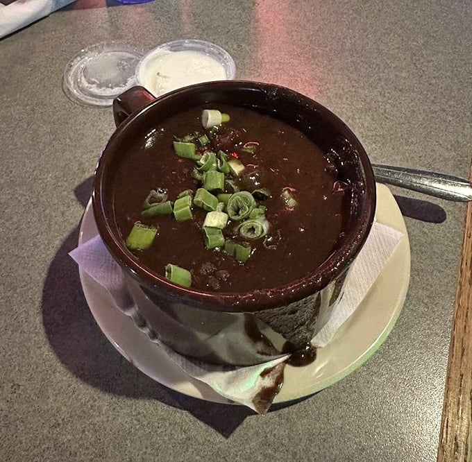 This Cuban Black Bean Soup isn't just a meal—it's a warm hug in a bowl, topped with a confetti of green onions.