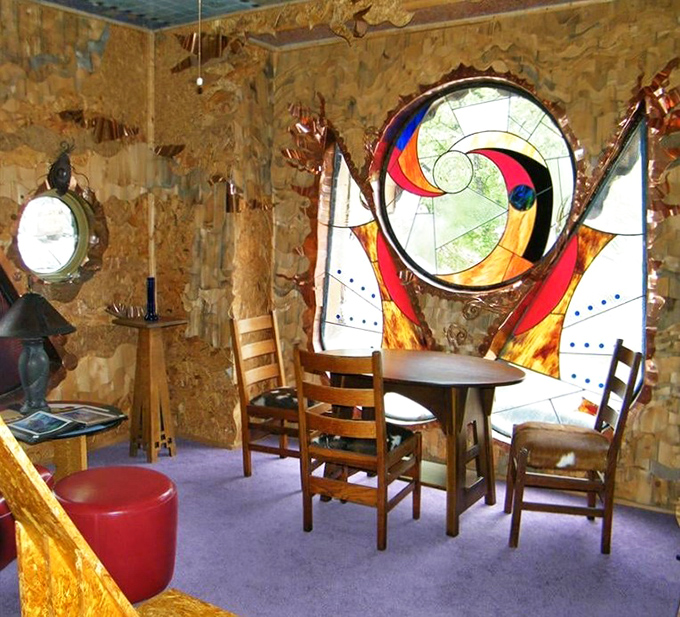 The dining area showcases a stunning stained glass porthole window, where everyday meals become magical experiences bathed in kaleidoscopic light.