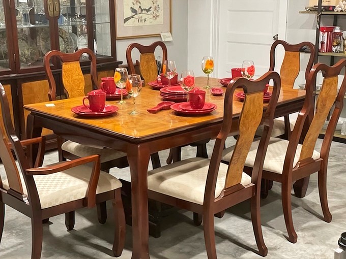 This elegant dining set, staged with vibrant red place settings, could host your next dinner party with more character than anything from a big box store.