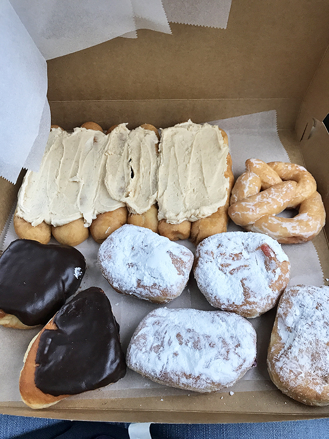 A box of joy containing frosted, glazed, and chocolate-dipped donuts. Notice how they're arranged like precious artifacts&mdash;which in the pastry world, they are.