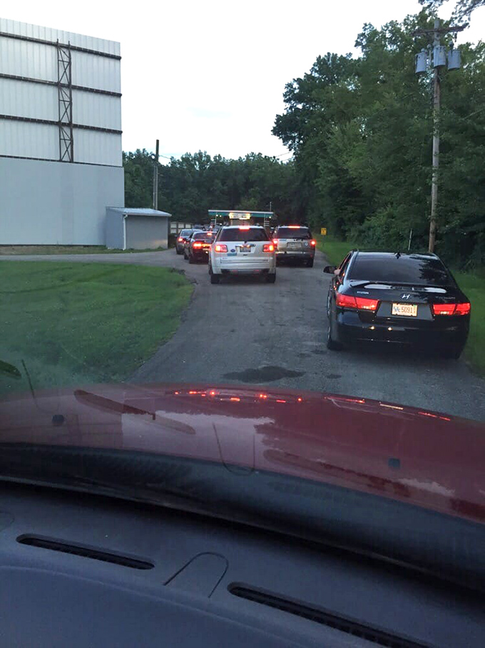 The anticipation builds as cars line up for admission. Each headlight a firefly guiding you toward an evening of big-screen magic.
