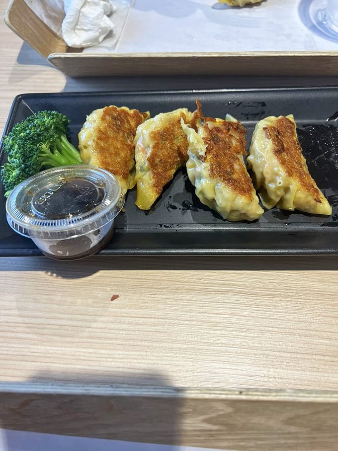 Golden-brown dumplings with the perfect crispy-to-juicy ratio, served with a side of broccoli that's trying its best to make you feel virtuous.