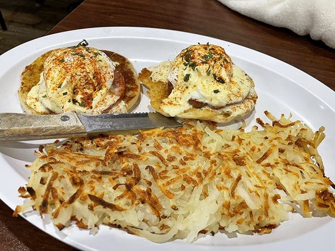 Eggs Benedict with perfectly crispy hash browns &ndash; a breakfast that says "today might be ordinary, but your first meal won't be."