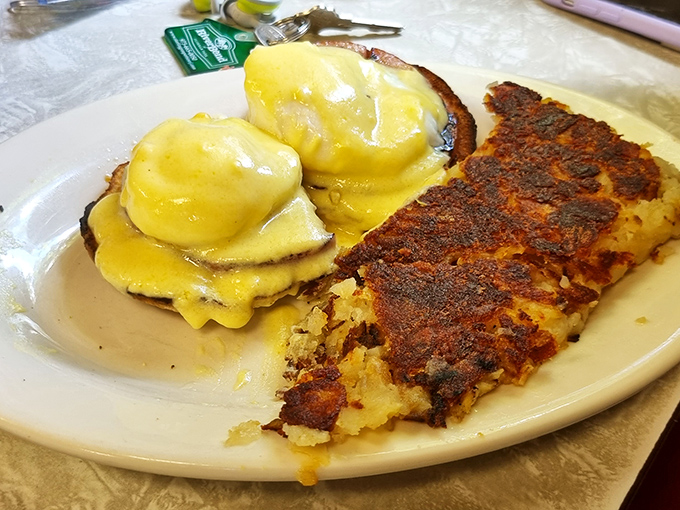 Eggs Benedict: The diner's version of morning luxury. Hollandaise sauce cascading over Canadian bacon like a yellow waterfall of happiness.