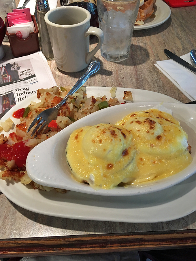 Eggs Benedict that would make a brunch enthusiast weep with joy. That hollandaise sauce looks like liquid sunshine coating perfectly poached eggs.