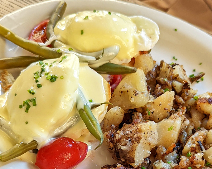 Benedict with a side of perfectly crisped potatoes &ndash; the breakfast diplomat that bridges the gap between fancy and comfort with diplomatic ease.