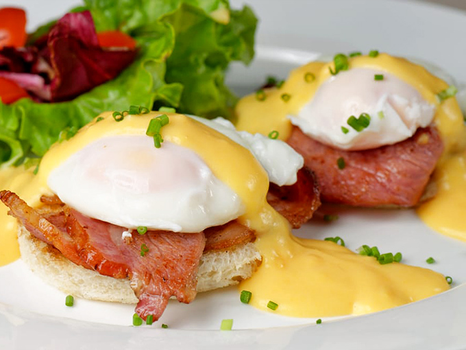 Eggs Benedict: where breakfast meets black tie optional. That hollandaise sauce is basically sunshine in condiment form.