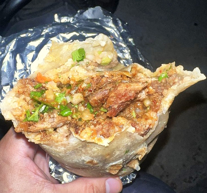 Unwrapped like a present, this burrito reveals its inner glory&mdash;a mosaic of flavors wrapped in a tortilla hug.