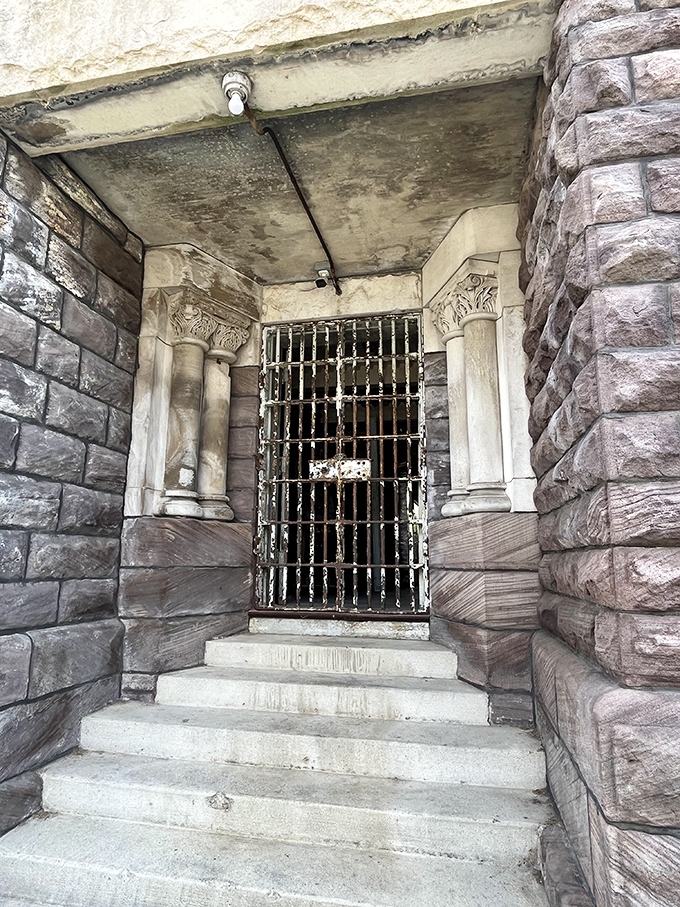 The entrance says "welcome" in the least welcoming way possible. Those stone columns and iron bars weren't designed for comfort&mdash;they were built to intimidate.