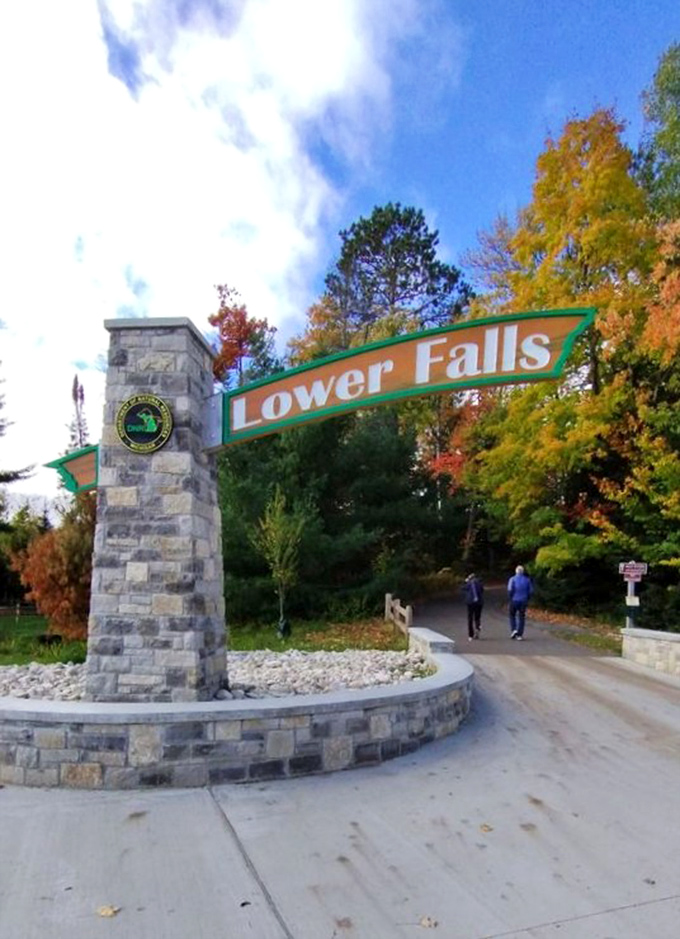 Autumn transforms the Lower Falls entrance into a painter's palette, proving that Michigan's fall colors rival New England's famous displays.
