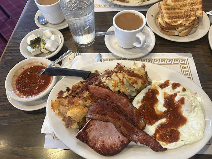 Behold the farmer's breakfast—scrambled eggs, ham, and those legendary hash browns. This is why farmers get up at dawn and why city folks drive for miles.