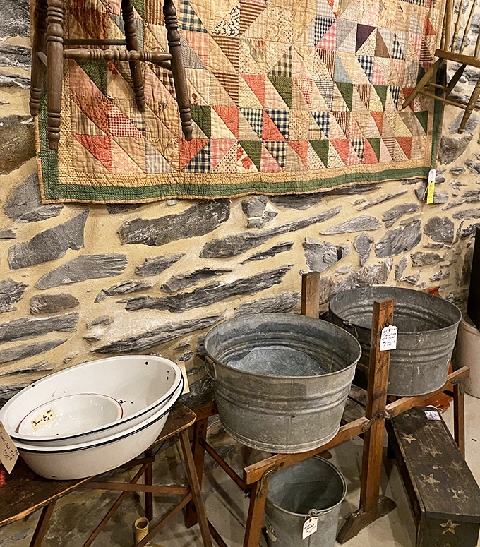 A handmade quilt draped over galvanized wash tubs&mdash;this vignette tells more about American domestic life than most history textbooks ever could.