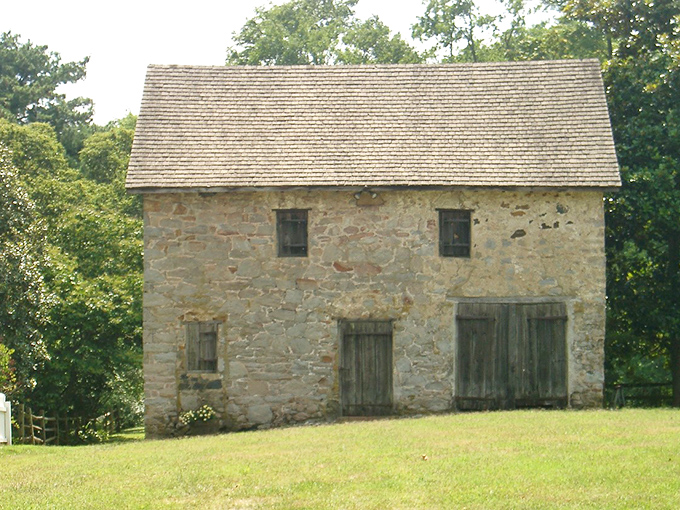 This fieldstone stable has weathered centuries with the quiet dignity of a structure that's seen it all. If these walls could talk, they'd probably brag about their craftsmanship.