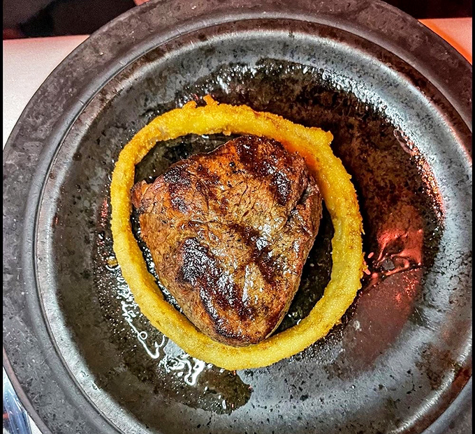 A filet mignon surrounded by a golden onion ring&mdash;like Saturn with its rings, but infinitely more delicious and definitely worth the trip.