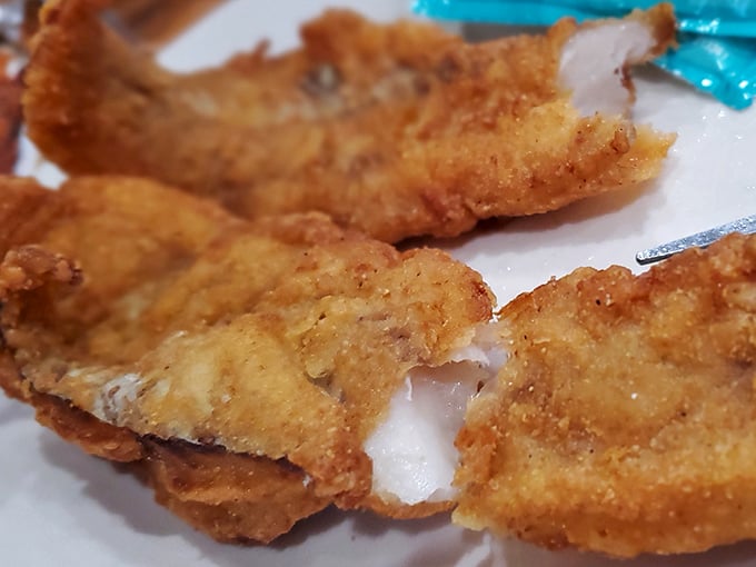 Golden-fried fish that would make coastal snobs reconsider their prejudice against landlocked seafood. Crispy perfection in every bite.