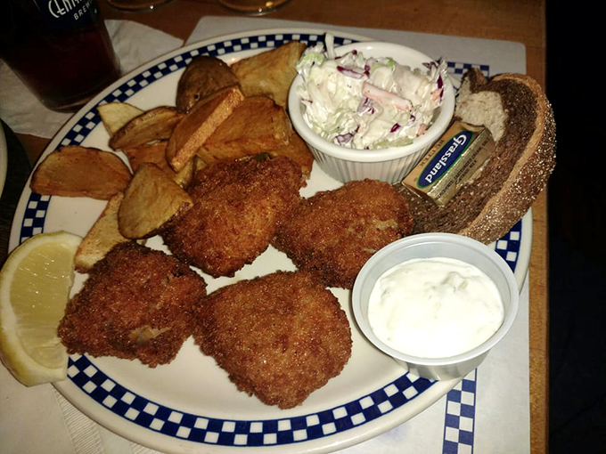 The Friday fish fry arrives on blue-checkered plates that have witnessed countless "oohs" and "aahs" from satisfied diners discovering crispy perfection.