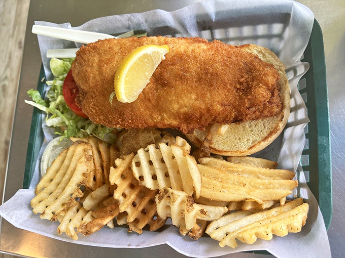 The fish sandwich that launched a thousand return visits, nestled in its basket like Neptune's treasure. Those waffle fries deserve their own fan club.