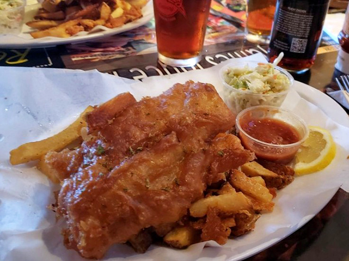 Fish and chips done right&mdash;golden-battered fish alongside thick-cut fries, with coleslaw standing by like a loyal sidekick.