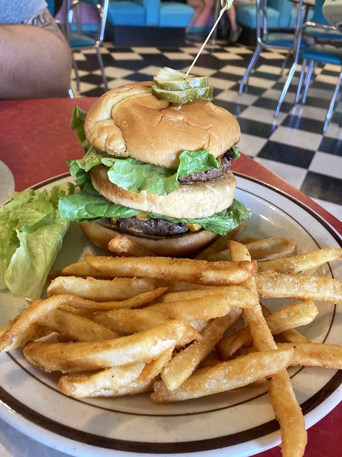 A burger that stands tall and proud, with fries so perfectly golden they could make a cardiologist temporarily reconsider their career choice. 