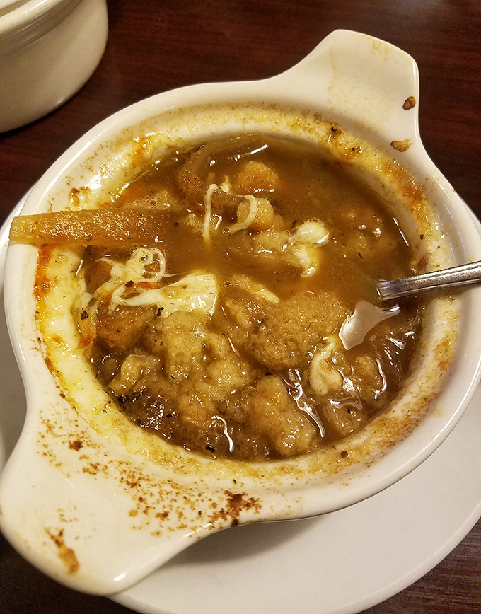 This isn't just soup&mdash;it's French onion therapy in a crock, with a golden crown of melted cheese that stretches dramatically with each spoonful.