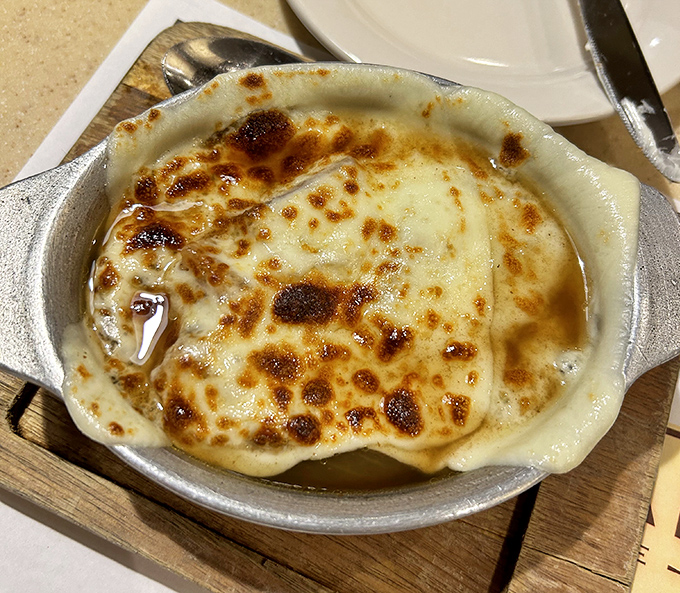 French onion soup with a cheese pull that deserves its own Olympic medal. Bubbling, golden perfection that's worth the inevitable shirt stain.
