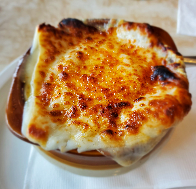 Behold the star of the show: French onion soup with a cheese cap worthy of a standing ovation.