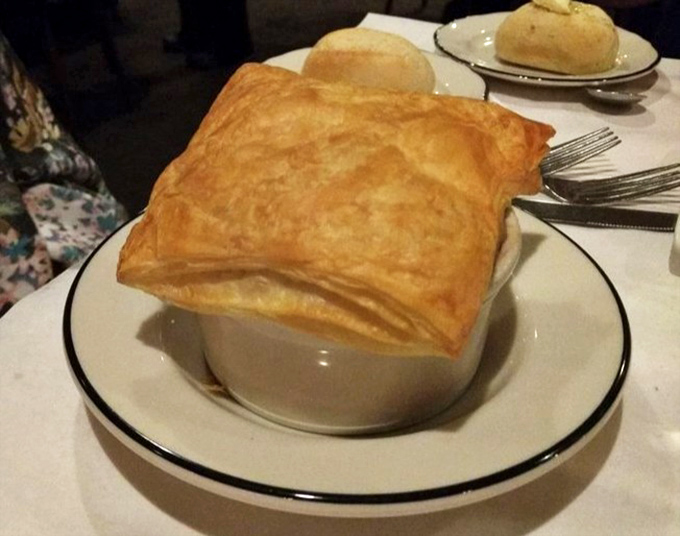 This isn't just soup—it's a French onion revelation under a cathedral of melted cheese that stretches with each spoonful.