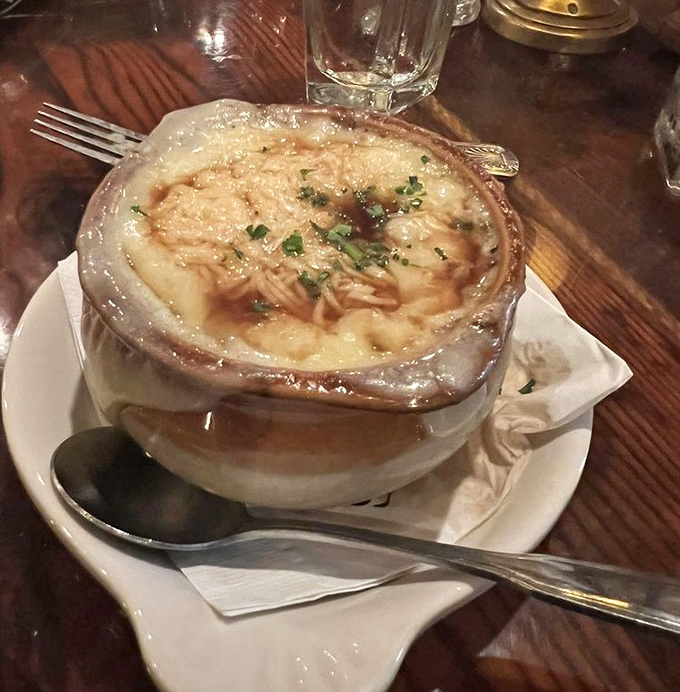 French onion soup arrives bubbling with cheese so stretchy it could double as entertainment while dining.