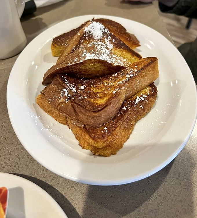 French toast dusted with powdered sugar dreams and golden-brown perfection that defies all breakfast logic.