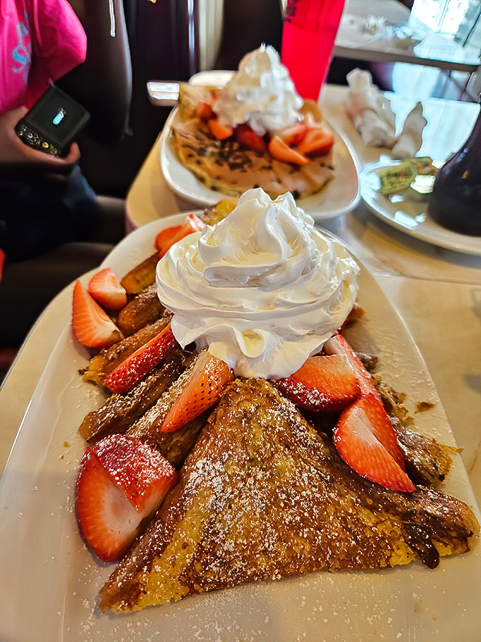 French toast that's dressed for success with fresh strawberries and enough whipped cream to make your cardiologist wince gloriously.
