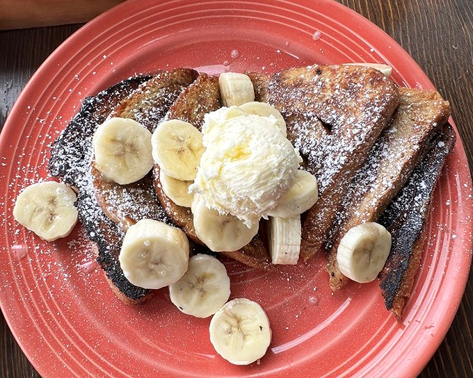 French toast that makes you question why you ever settled for lesser versions. Those bananas aren't just toppings&mdash;they're supporting actors in a breakfast blockbuster.