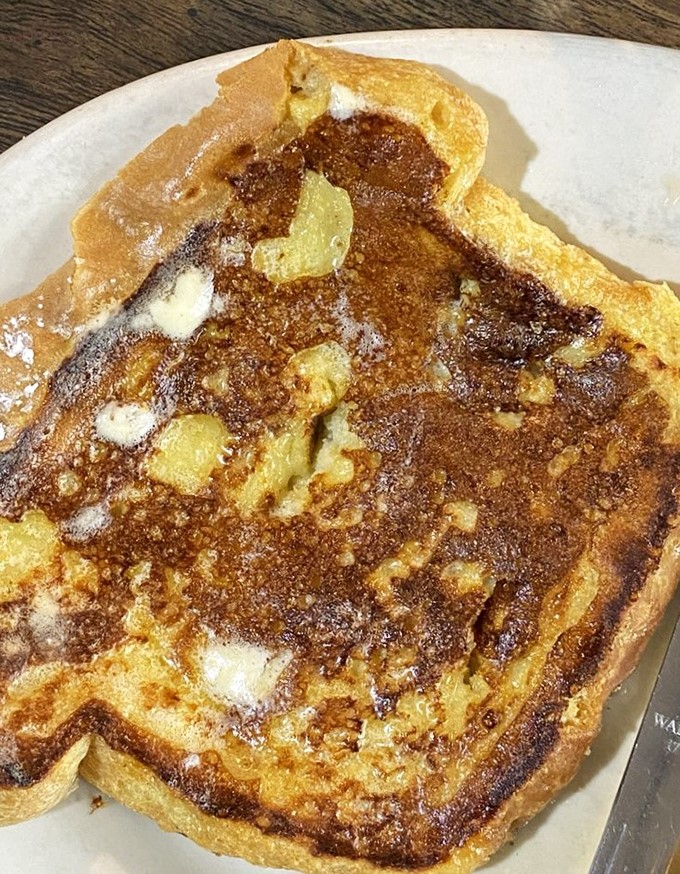 French toast that's achieved the impossible balance&mdash;crispy edges, custardy center, and enough butter to make a cardiologist wince but worth every delicious moment.