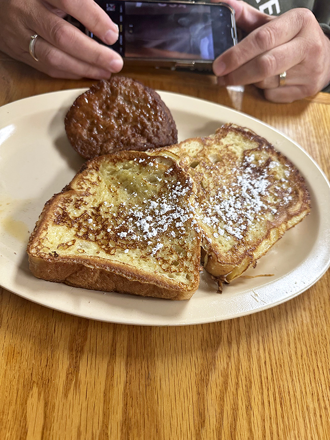 French toast dusted with powdered sugar and a side of sausage&mdash;proof that sometimes the simplest breakfast combinations are culinary poetry on a plate.