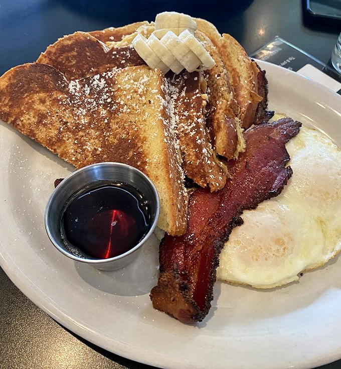 French toast that makes regular bread feel inadequate. Those banana slices and maple syrup aren't garnishes&mdash;they're supporting actors in a breakfast blockbuster.