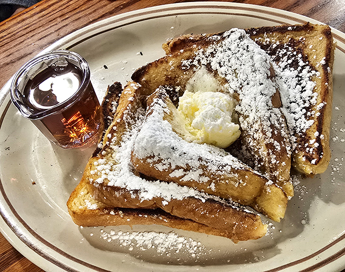 French toast that makes you question every other breakfast you've ever had. Dusted with powdered sugar and topped with butter, it's morning decadence at its finest.
