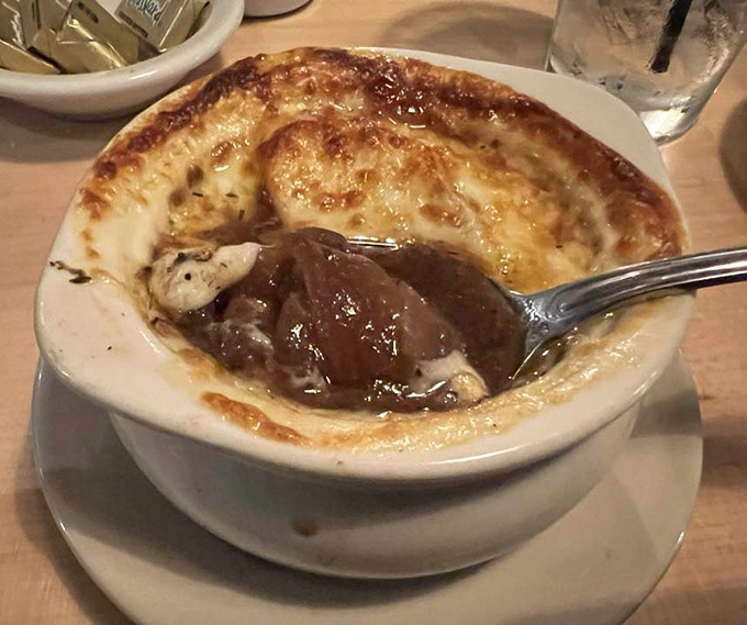 French onion soup with a cheese cap so perfect it deserves its own Instagram account. Dive in and discover the savory treasure below.