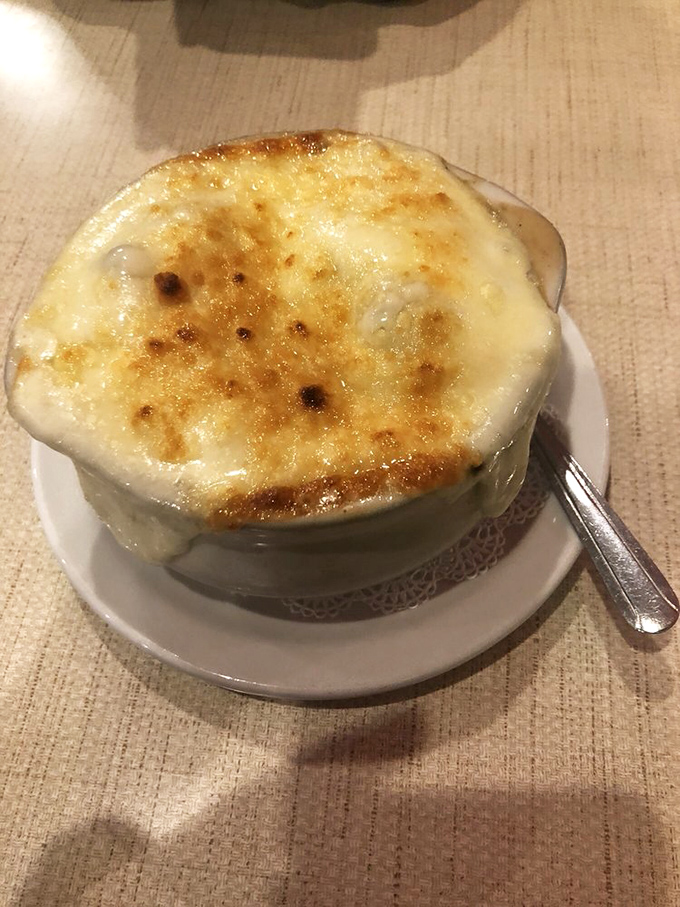 French onion soup with a crown of bubbling, browned cheese. It's like wearing a comfort food tuxedo—elegant yet deeply satisfying.