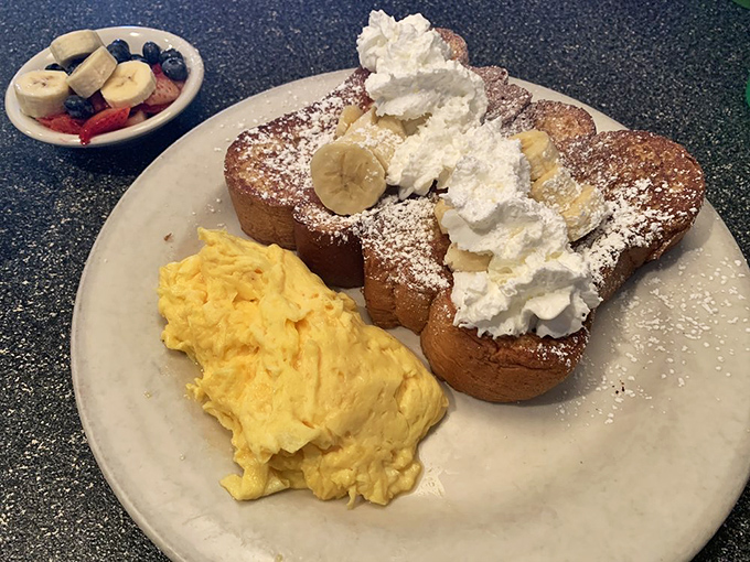 French toast that's dressed for success with fresh berries, bananas, and enough whipped cream to make your cardiologist wince approvingly.