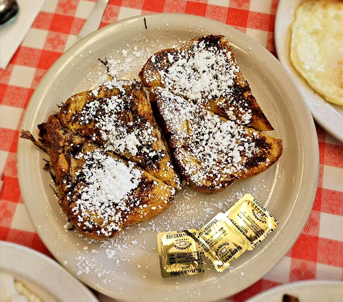 French toast dusted with powdered sugar &ndash; the breakfast equivalent of wearing pajamas to a fancy party. Deliciously rebellious and absolutely worth it.