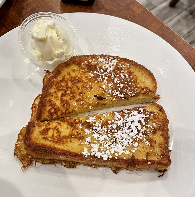 The legendary French toast &ndash; golden-brown perfection dusted with powdered sugar, waiting for that first magical bite that justifies setting your alarm.